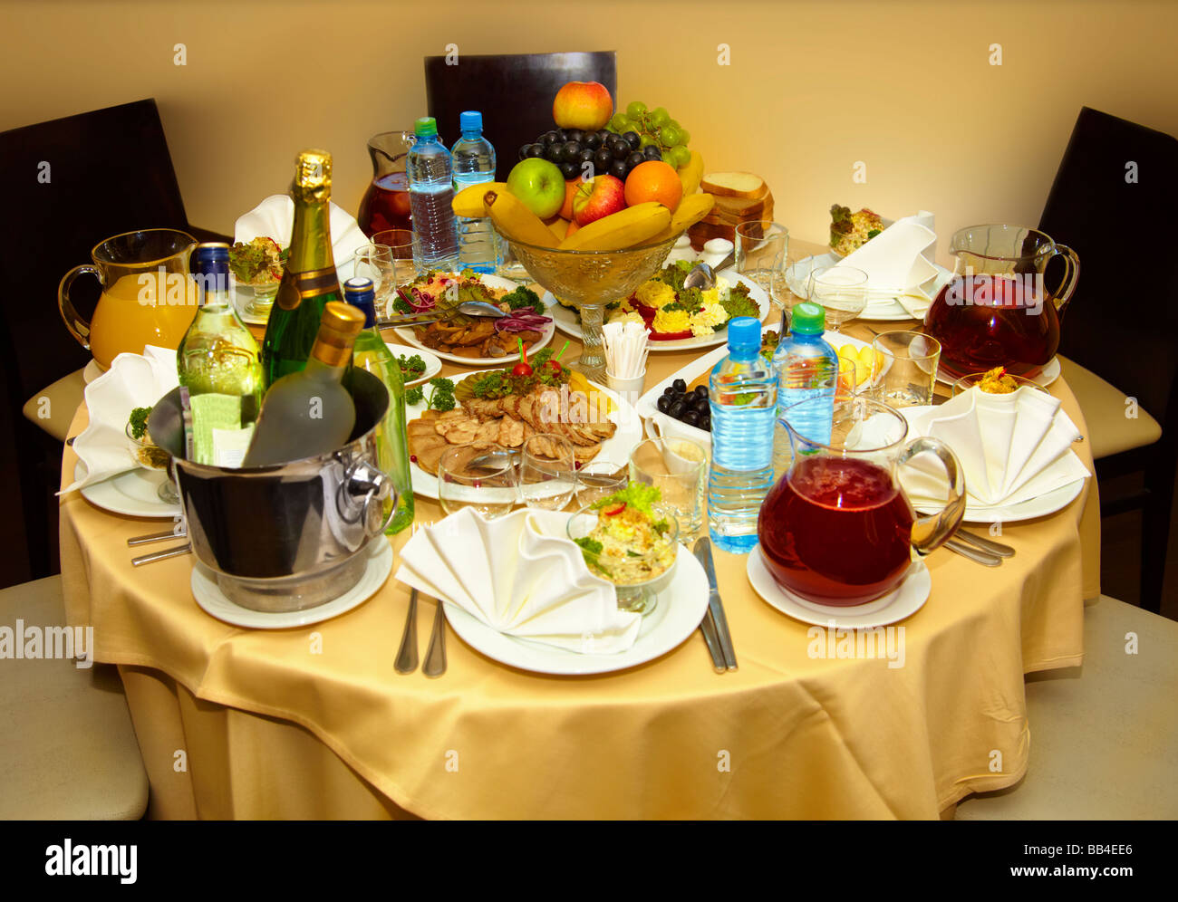 Round table with drinks appetizers salads a boiled pork and fruit Stock ...