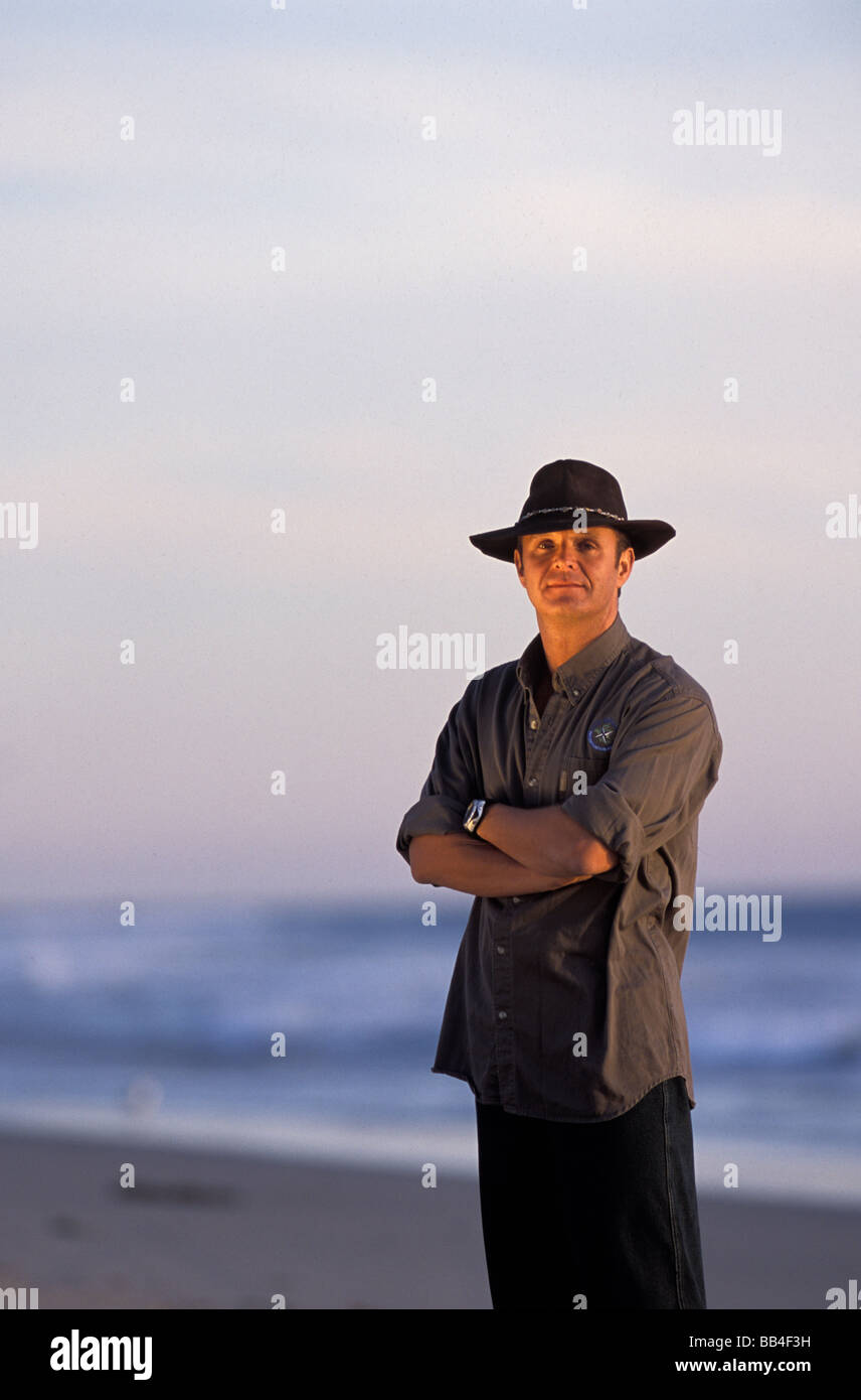 Male TV producer posing for a portrait on a beach Stock Photo - Alamy