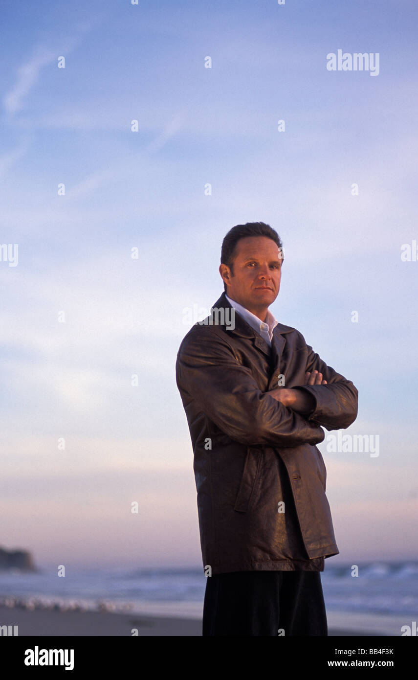 Male TV producer posing for a portrait on a beach Stock Photo - Alamy
