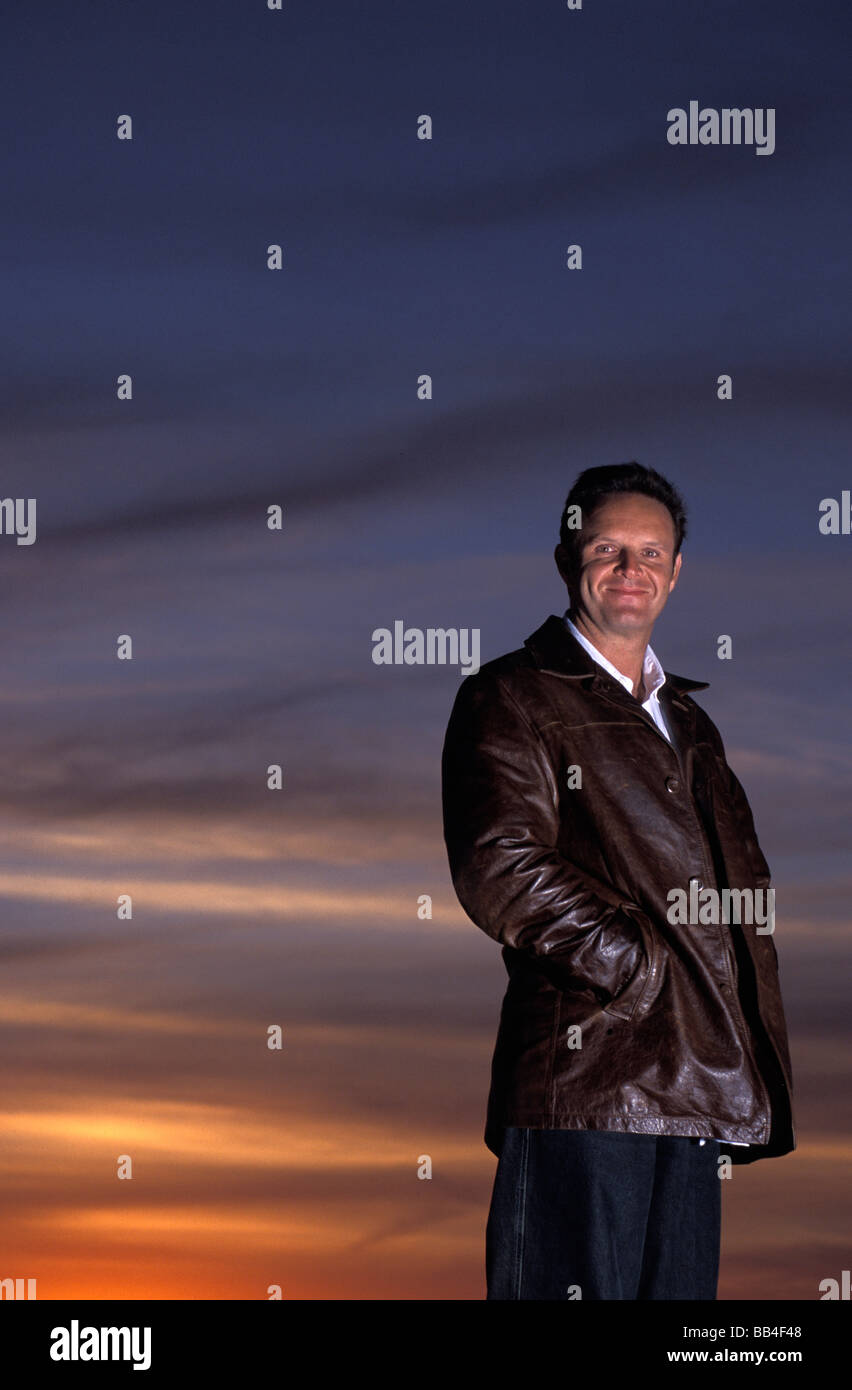 Male TV producer posing for a portrait on a beach Stock Photo - Alamy