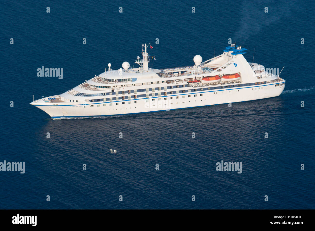 Europe, Greece, Santorini. White cruise ship, Seabourn Spirit, moving ...