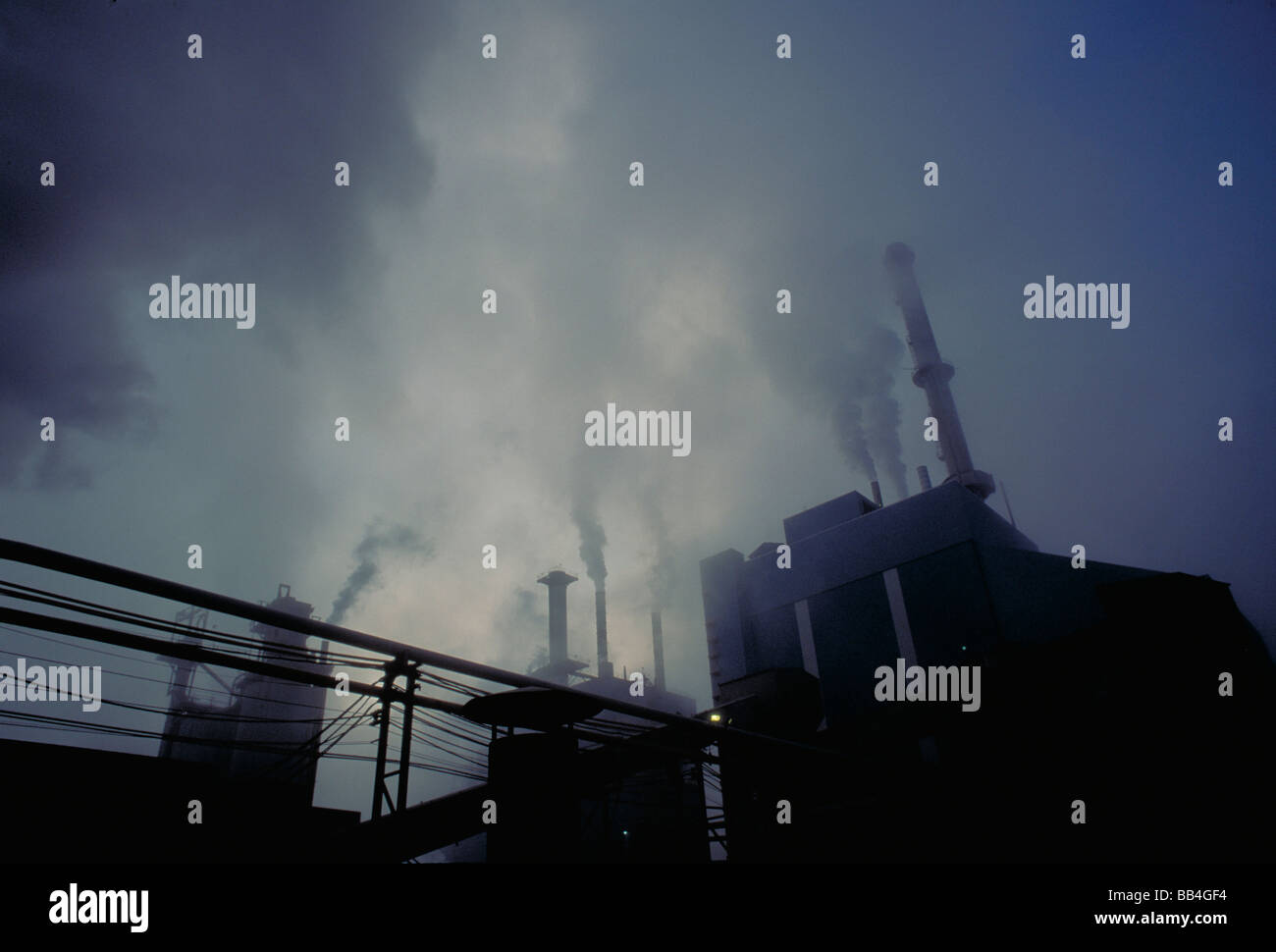 Smoke raises from a factory Stock Photo - Alamy