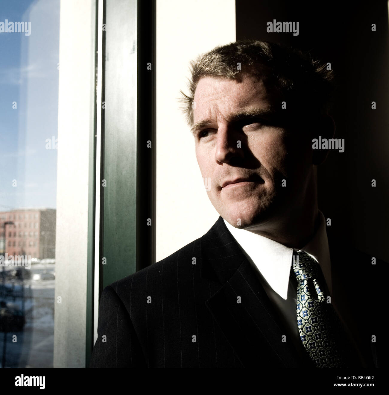 business man in an office looking out window, Portland, Maine, New ...