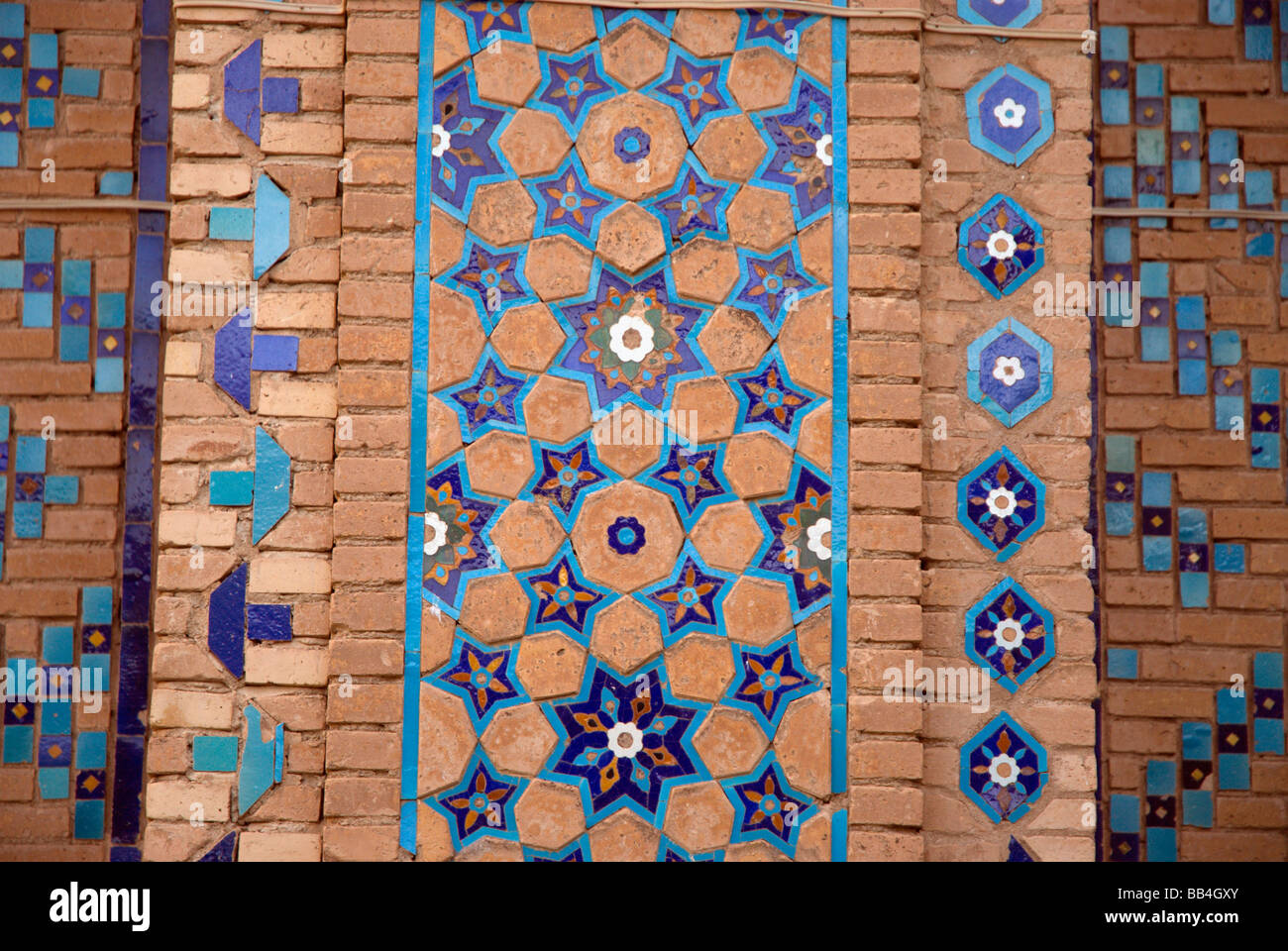 Ancient tiles of blue ceramic decorate the walls of the Sufi shrine of ...