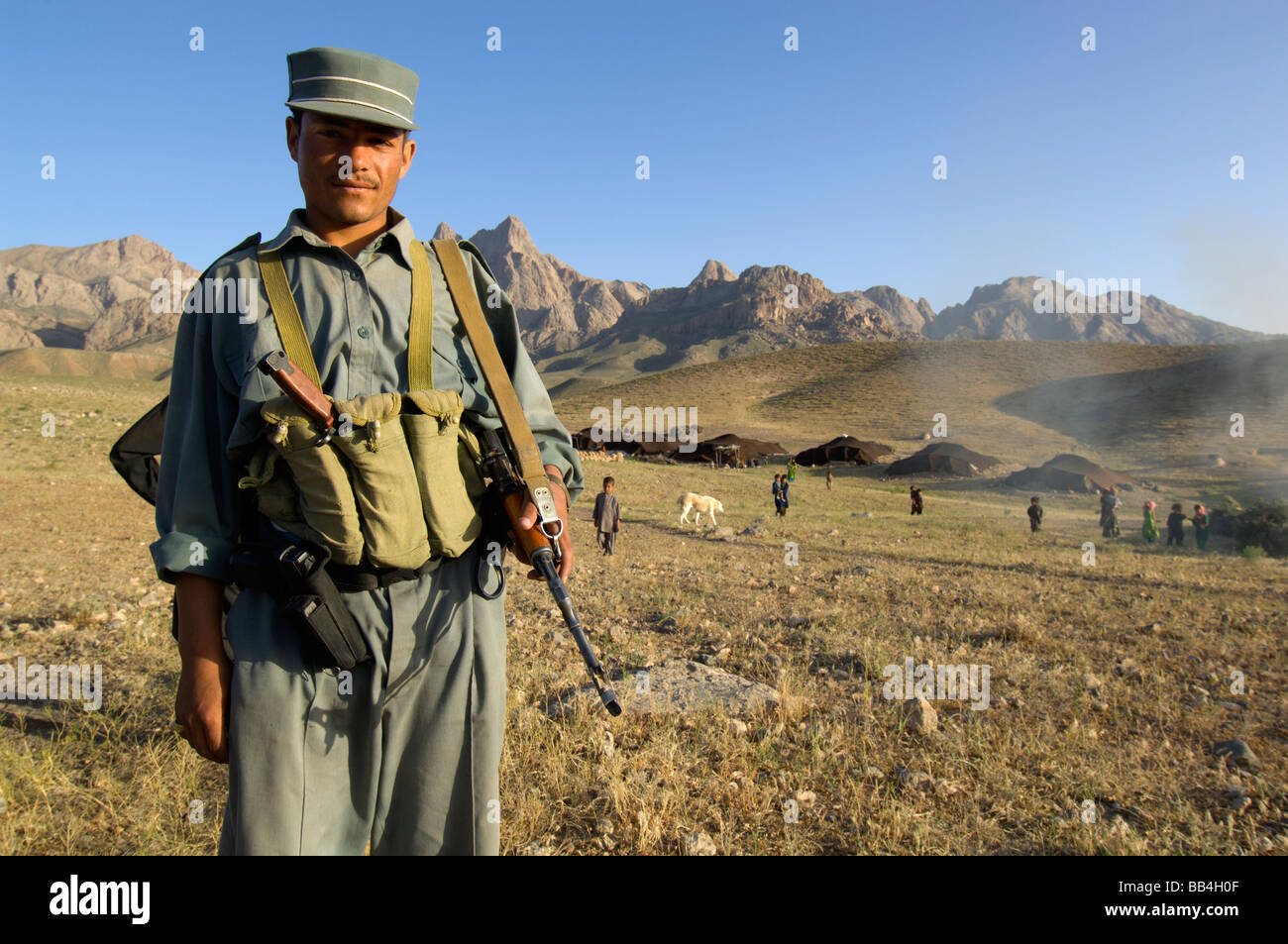 An Afghan policeman poses in front of a Pashtun shepherds' camp after a ...