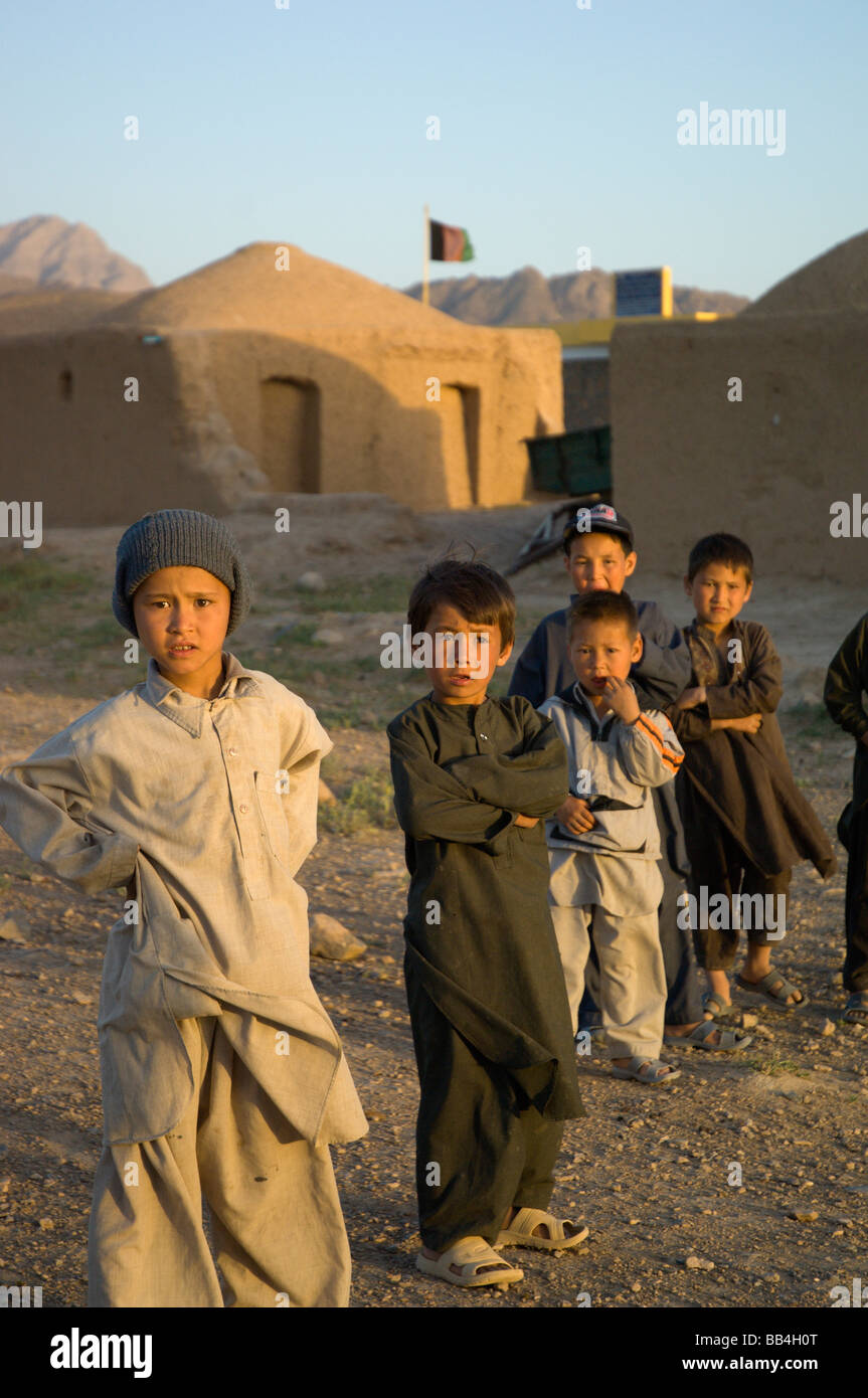Pashtun boys stand outside their mud homes in a village near the desert ...