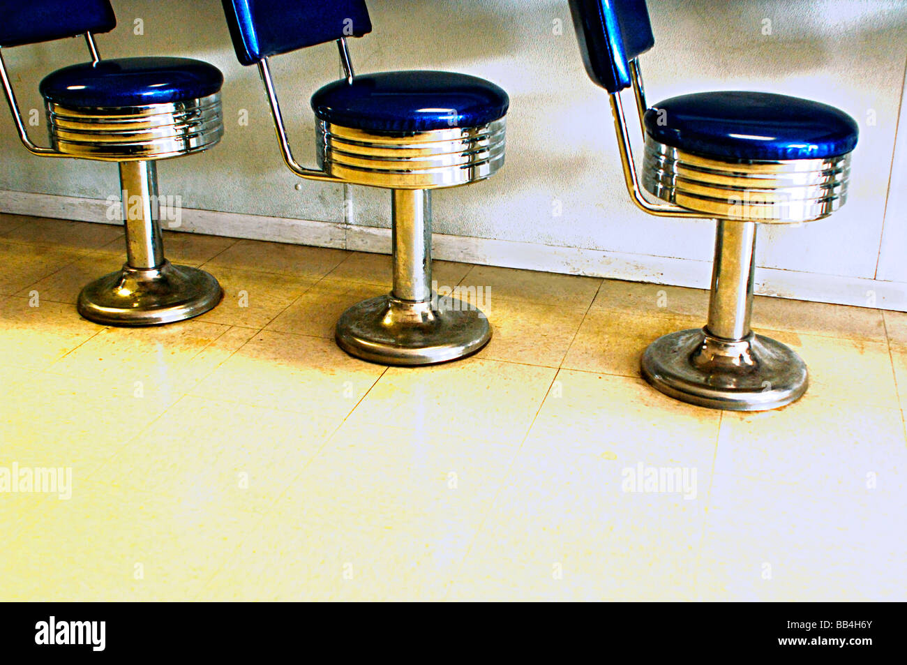 Blue counter stools in a charming 1950s style diner make for an ...