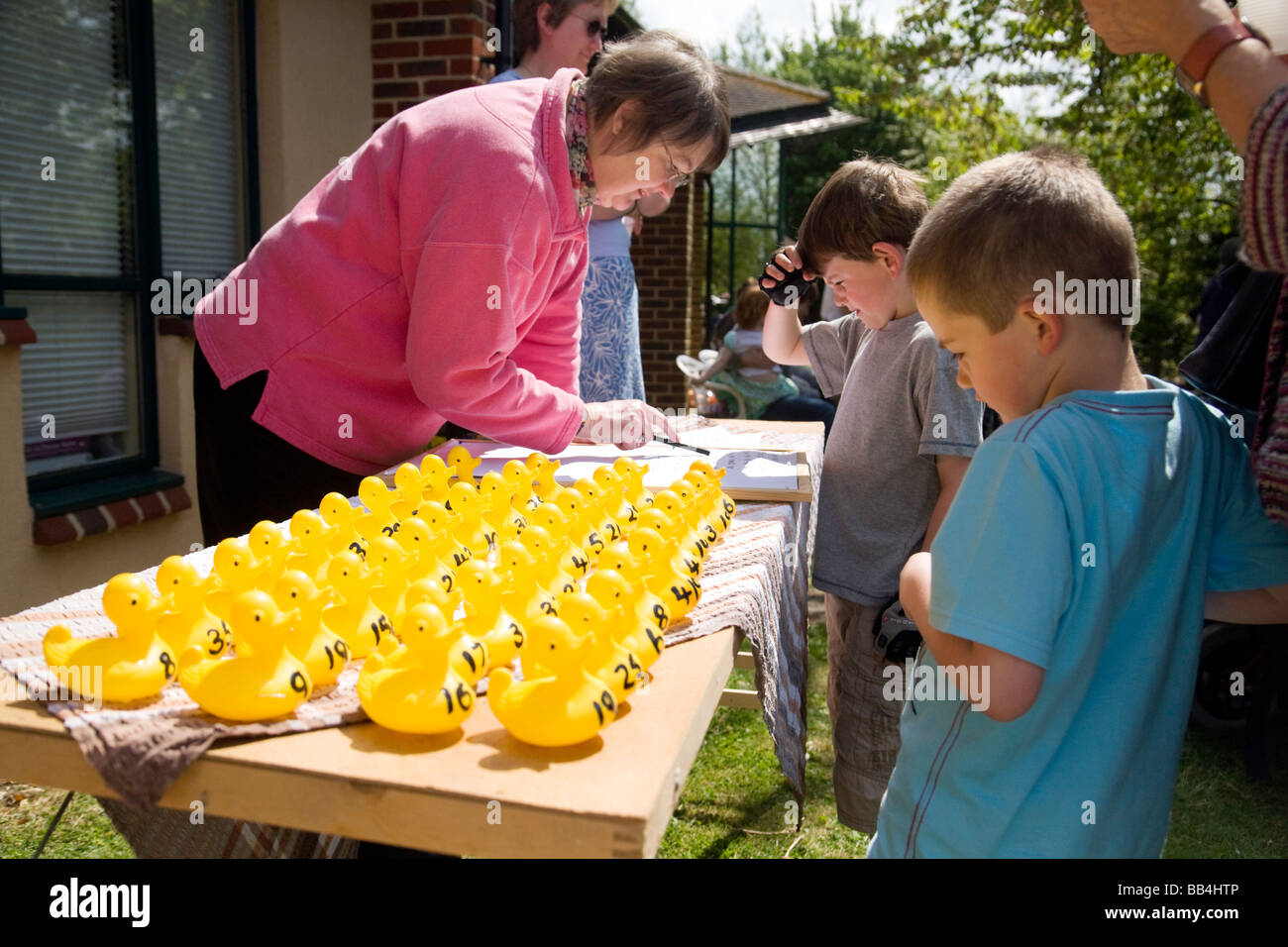 Children view the participants in a Charity plastic duck race at ...