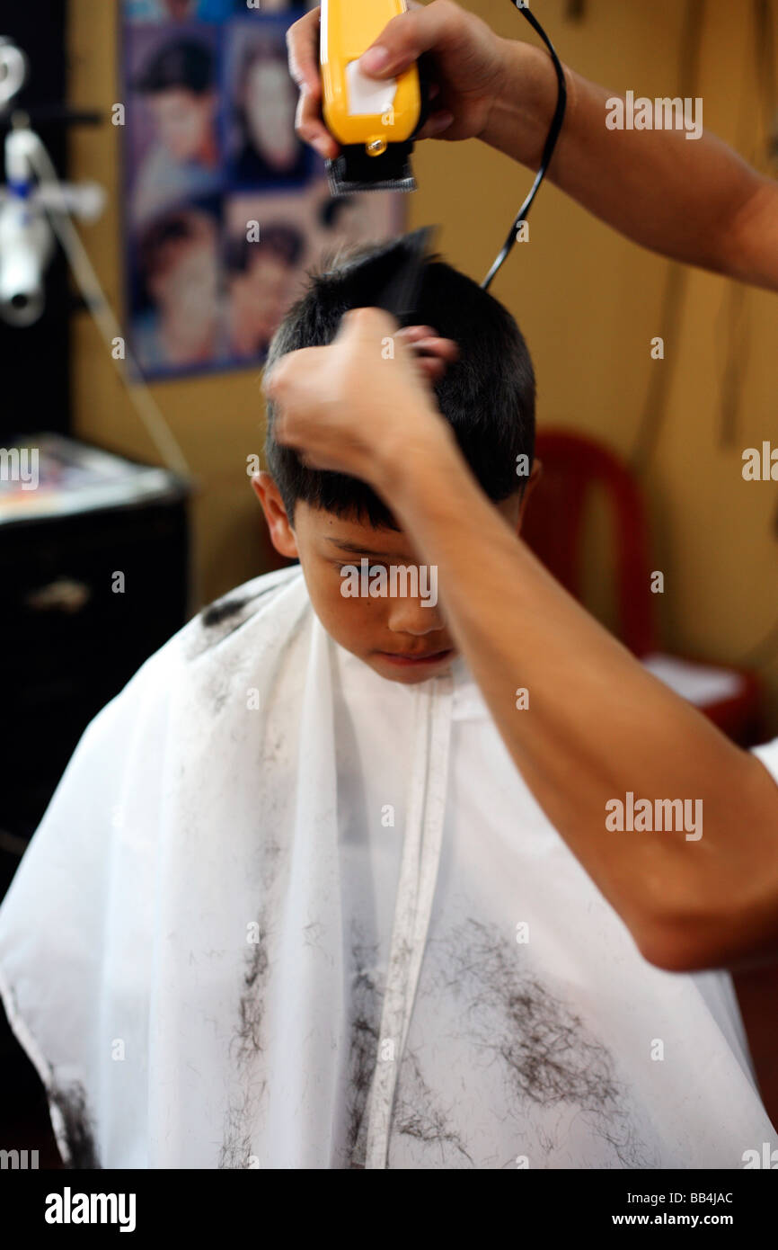A young hispanic little boy gets his hair cut in Antigua, Guatemala ...