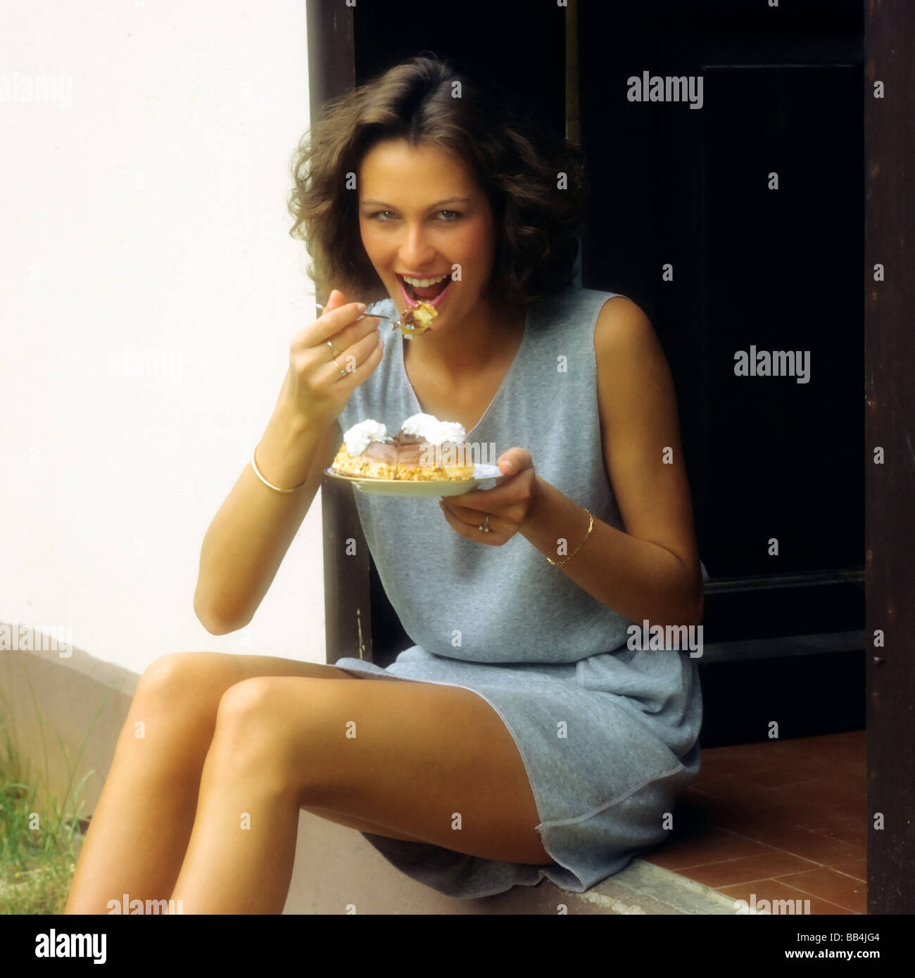 YOUNG WOMAN EATING PASTRY Stock Photo - Alamy
