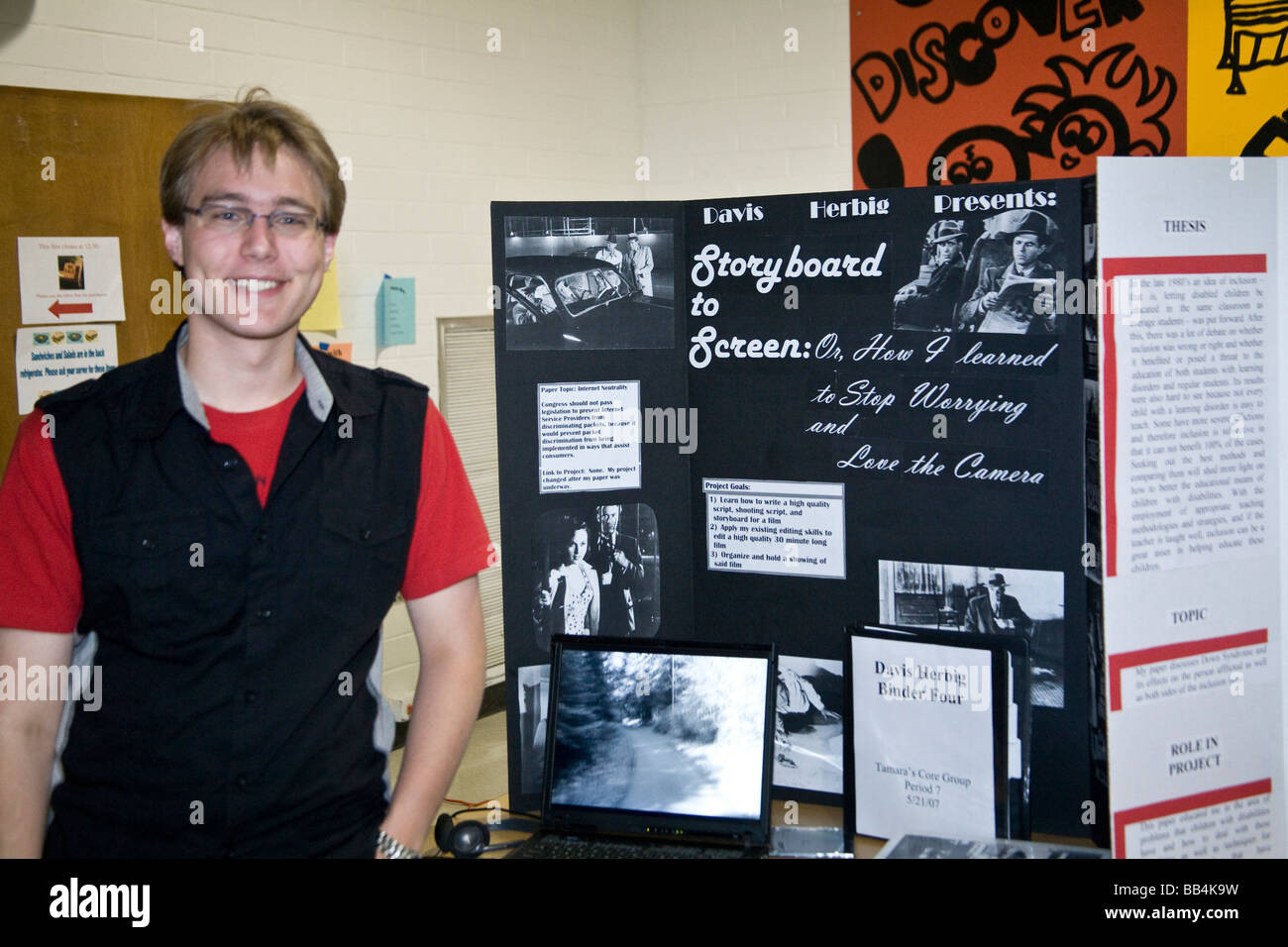 A proud high school student displays his multimedia project on film at ...