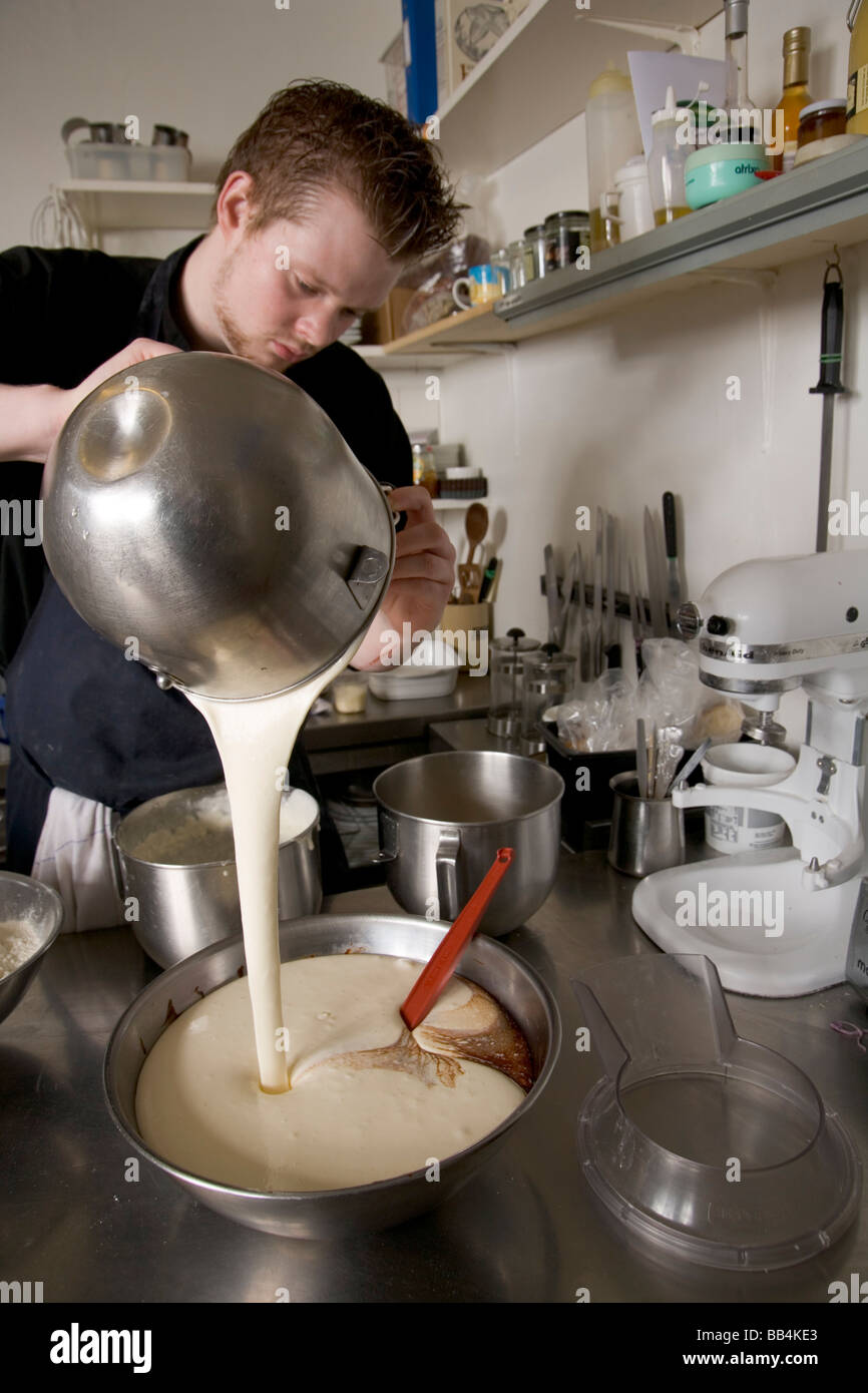 Professional chef at work in a restaurant kitchen, chocolate mousse ...