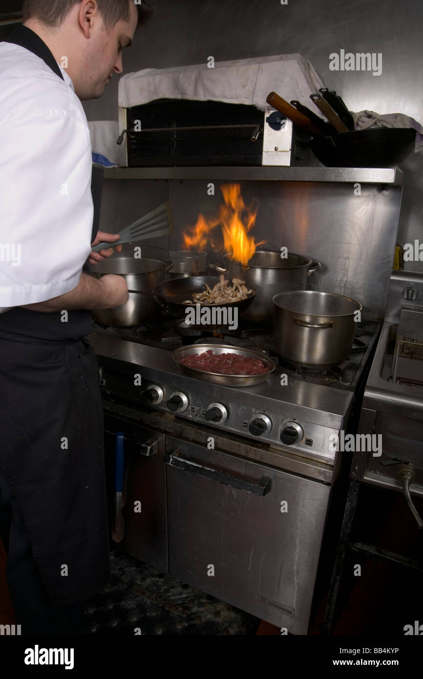 Professional chef at work in a restaurant kitchen, lardons Stock Photo ...