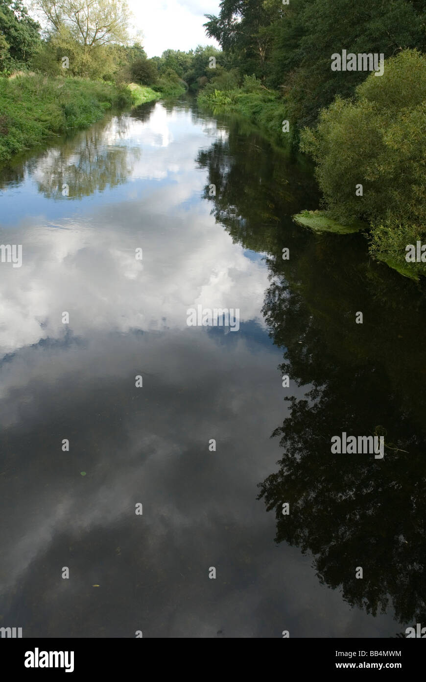 Clouds reflected in the waters of the Little Ouse river Norfolk England ...