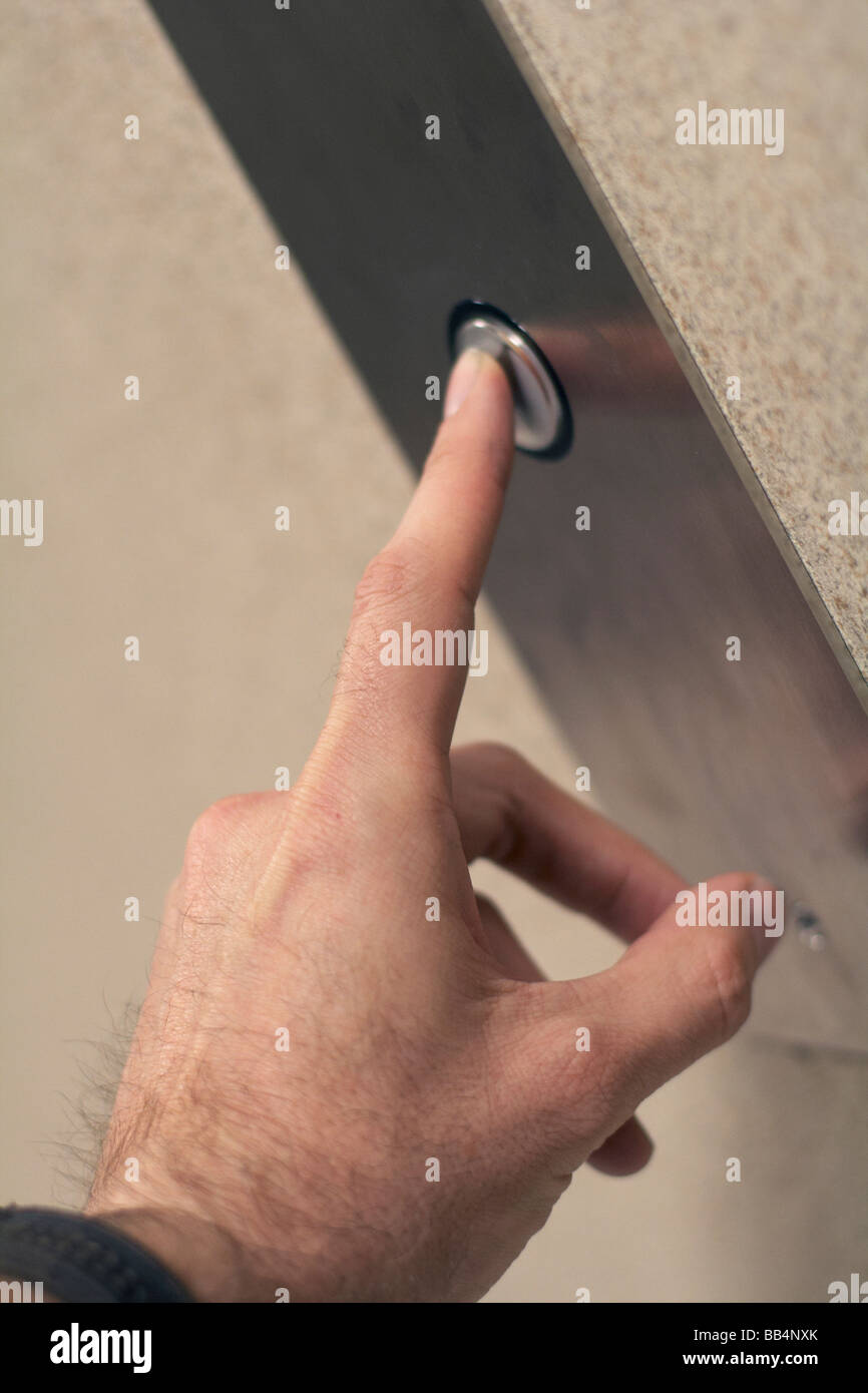 A hand pushing elevator buttons Stock Photo - Alamy