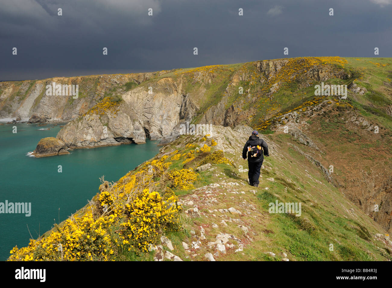 A female walker on Dinas Fawr, a promontory of rock leading off the ...