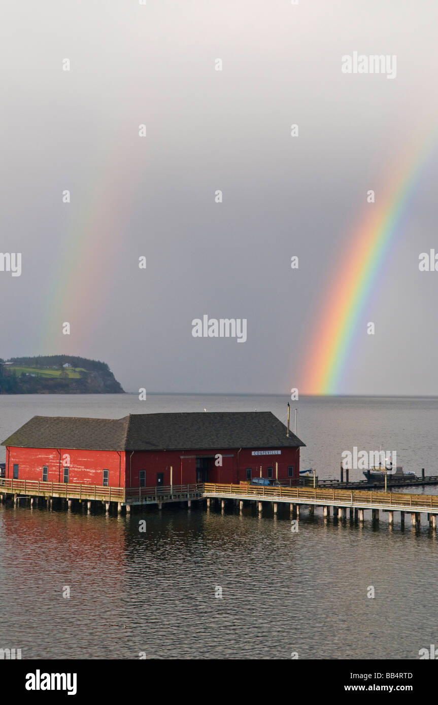 USA, WA, Whidbey Island. Vibrant double rainbow in Penn Cove backdrop ...