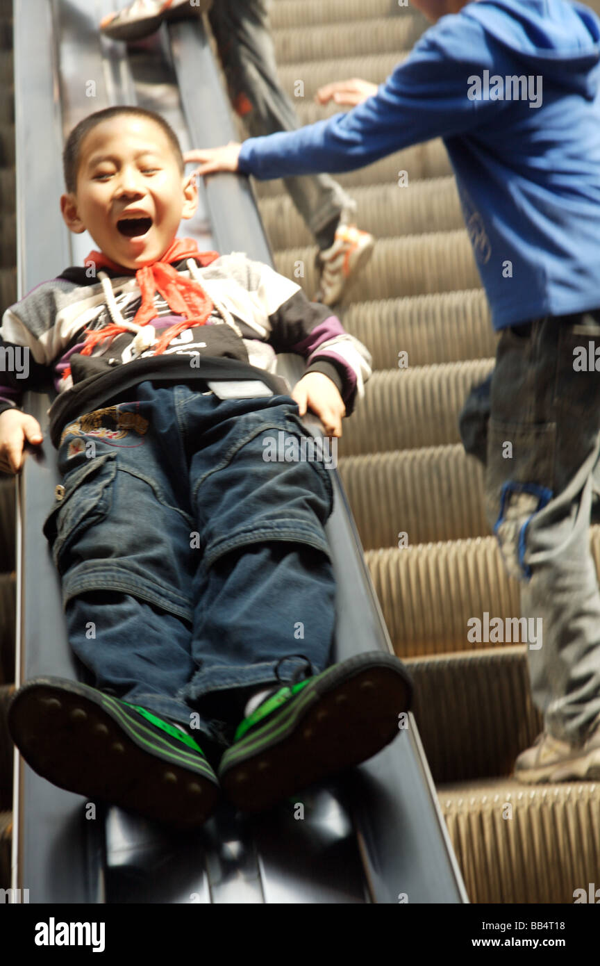kids playing on escalator in xi'an China Stock Photo - Alamy