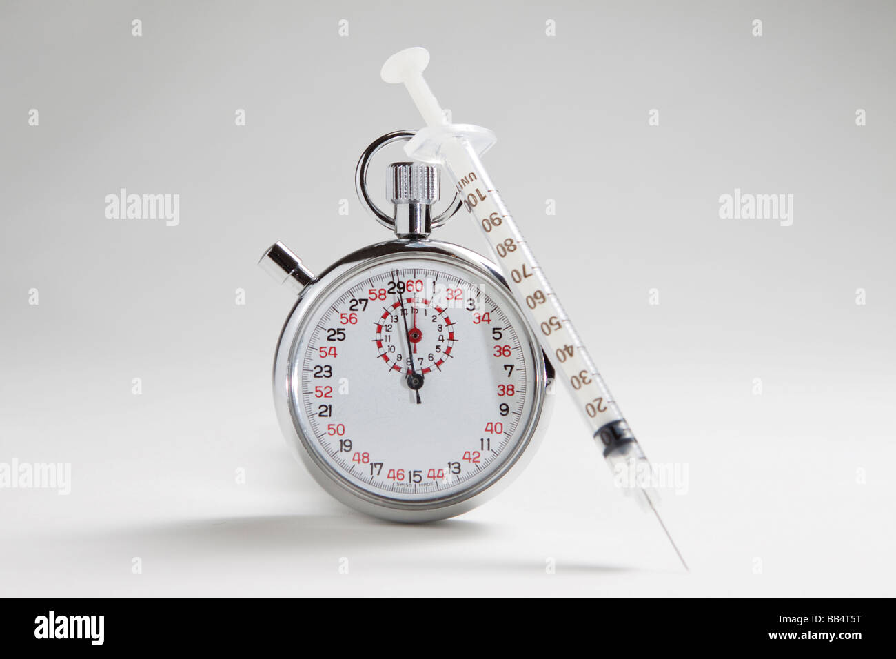 stopwatch and syringe Stock Photo - Alamy