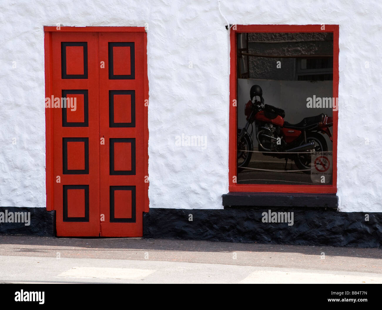Europe, Ireland, Glenties. Reflection of a red motorcycle in a window ...