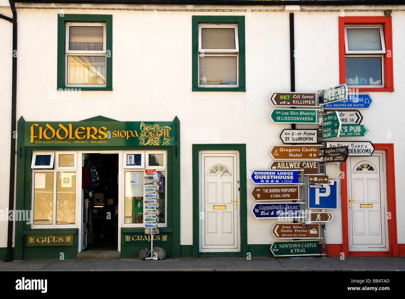 Europe, Ireland, Ballyvaughan. Store fronts and an informative sign ...
