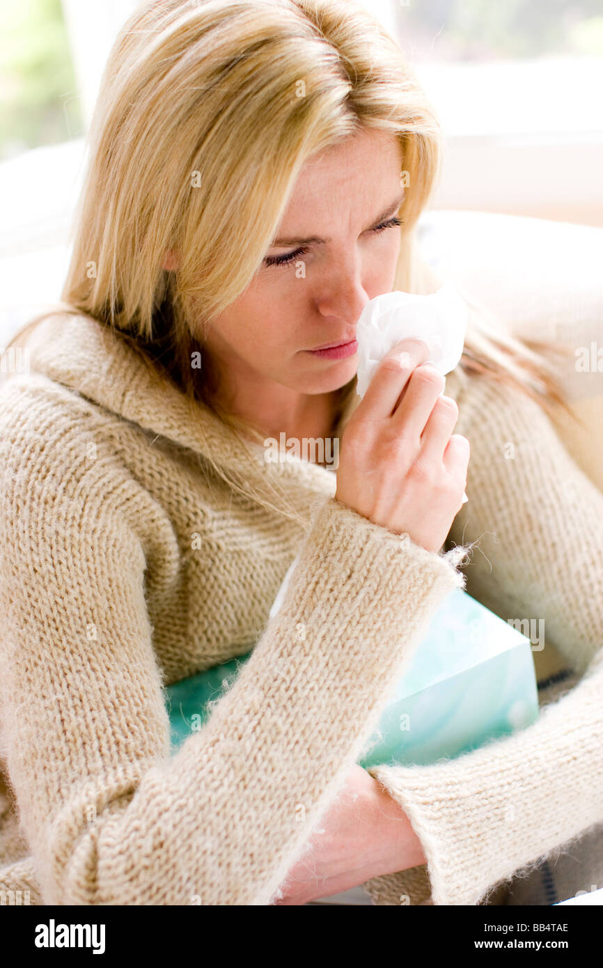 Girl with cold blowing nose Stock Photo - Alamy