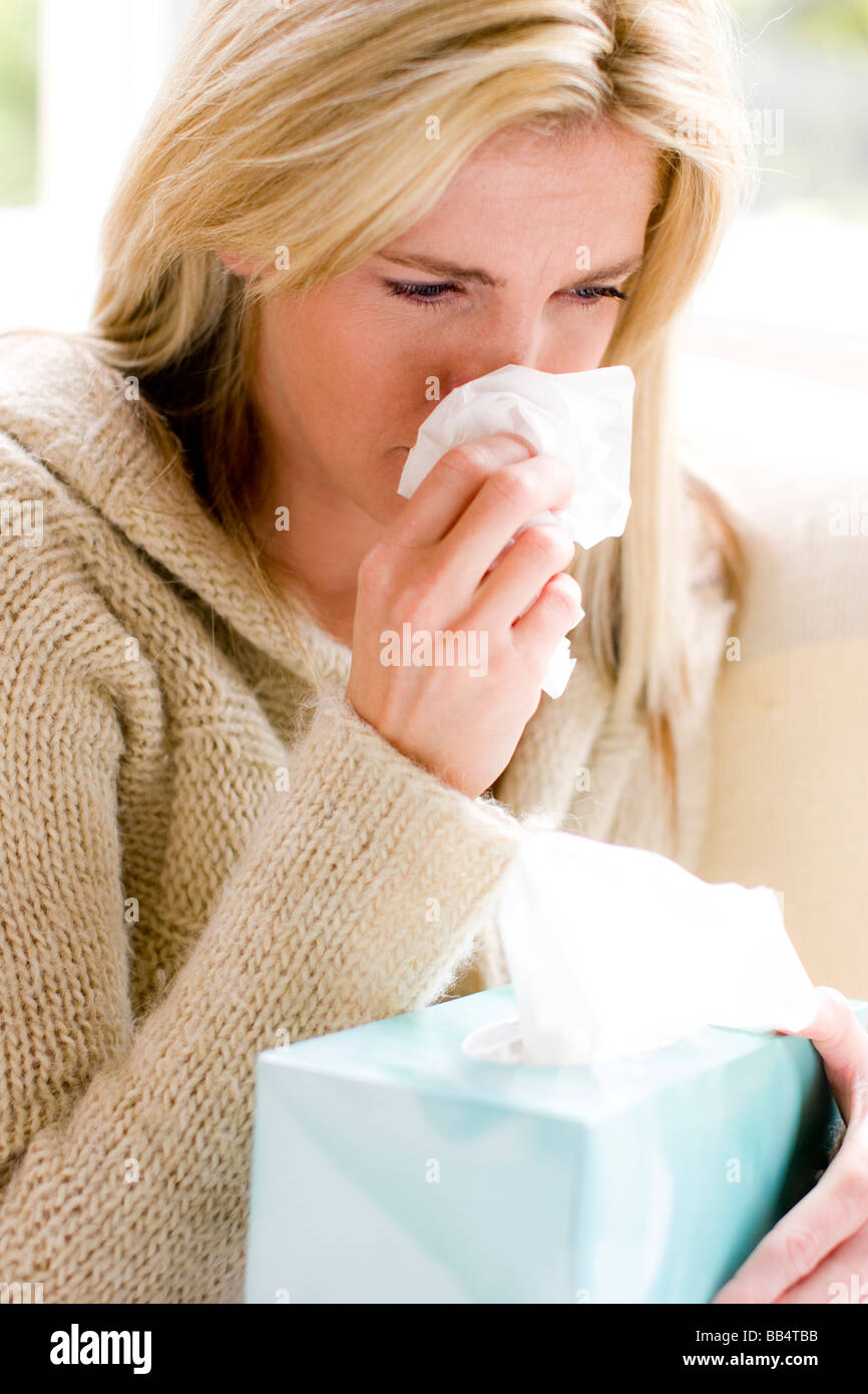 Girl with cold blowing nose Stock Photo - Alamy