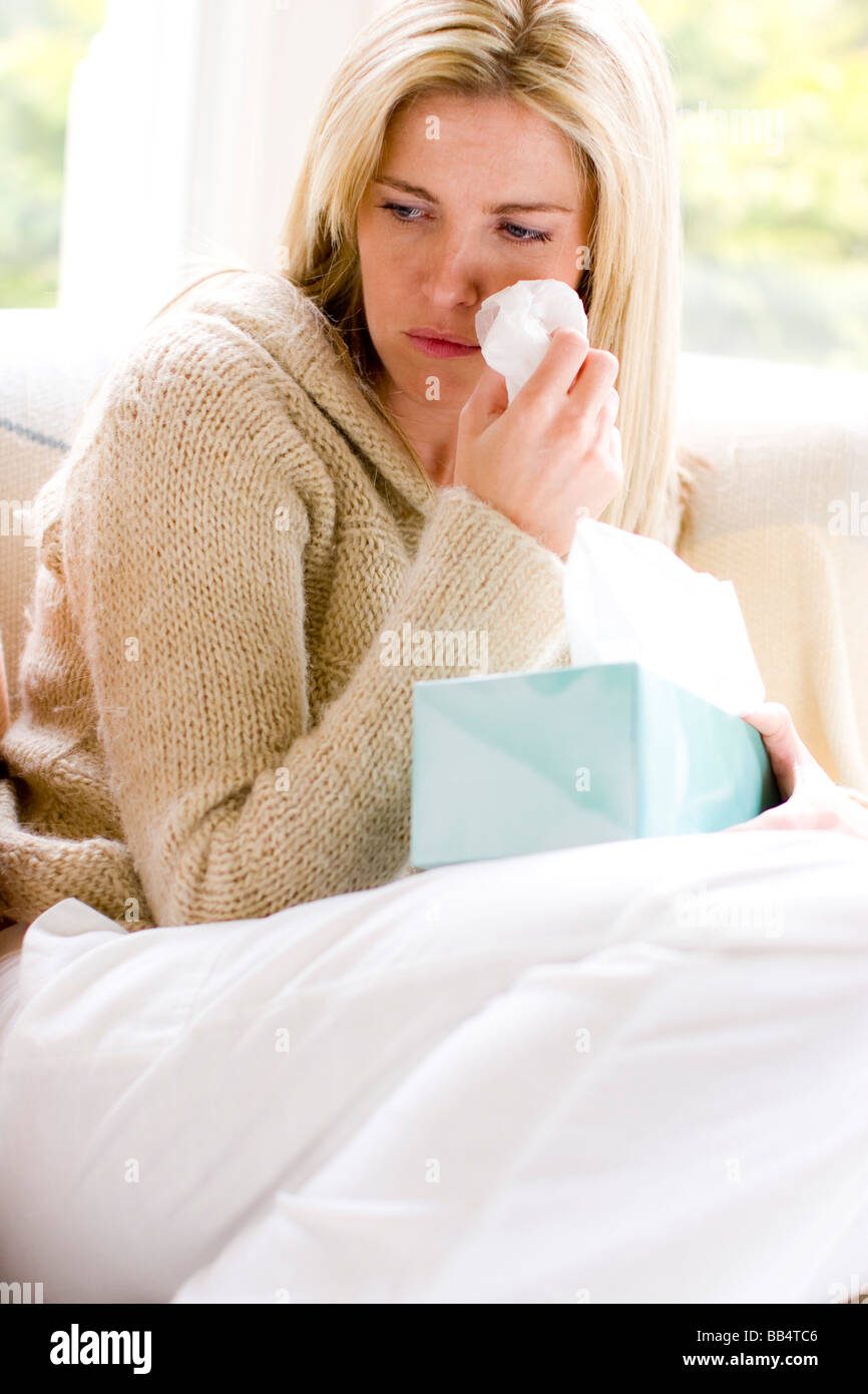 Girl with cold blowing nose Stock Photo - Alamy