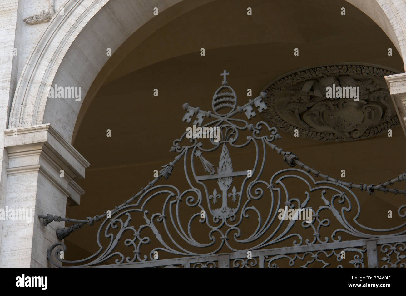 Wrought iron fence and stucco with coat of arms of pope Leo XIII Pecci ...