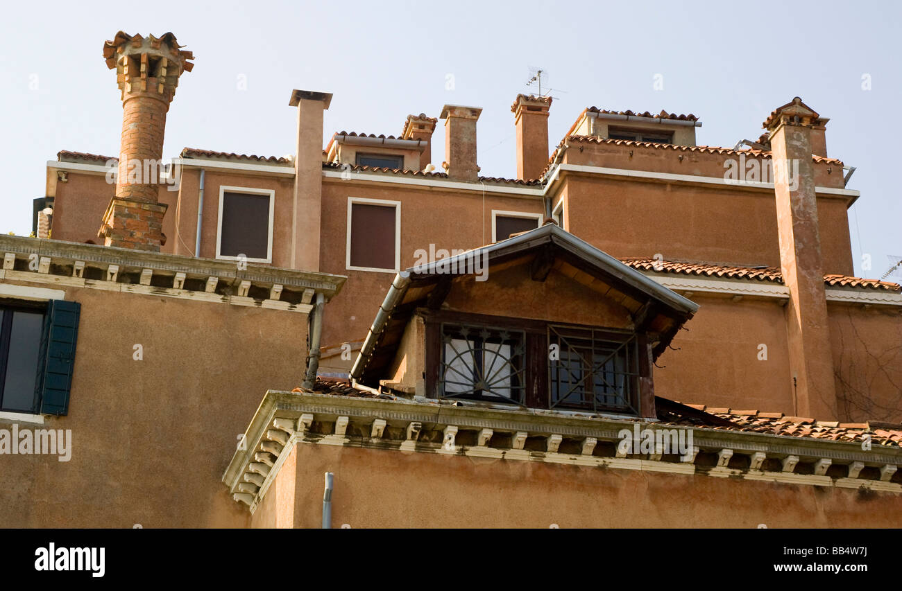 Europe, Italy, Venice. Tiled roofs, chimneys and windows of a colorful ...