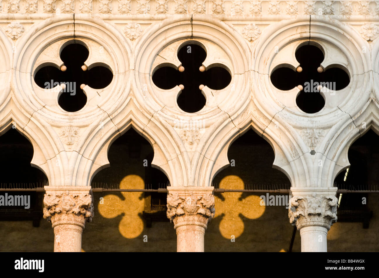 Europe, Italy, Venice. Sunlight on architectural designs form patterns ...