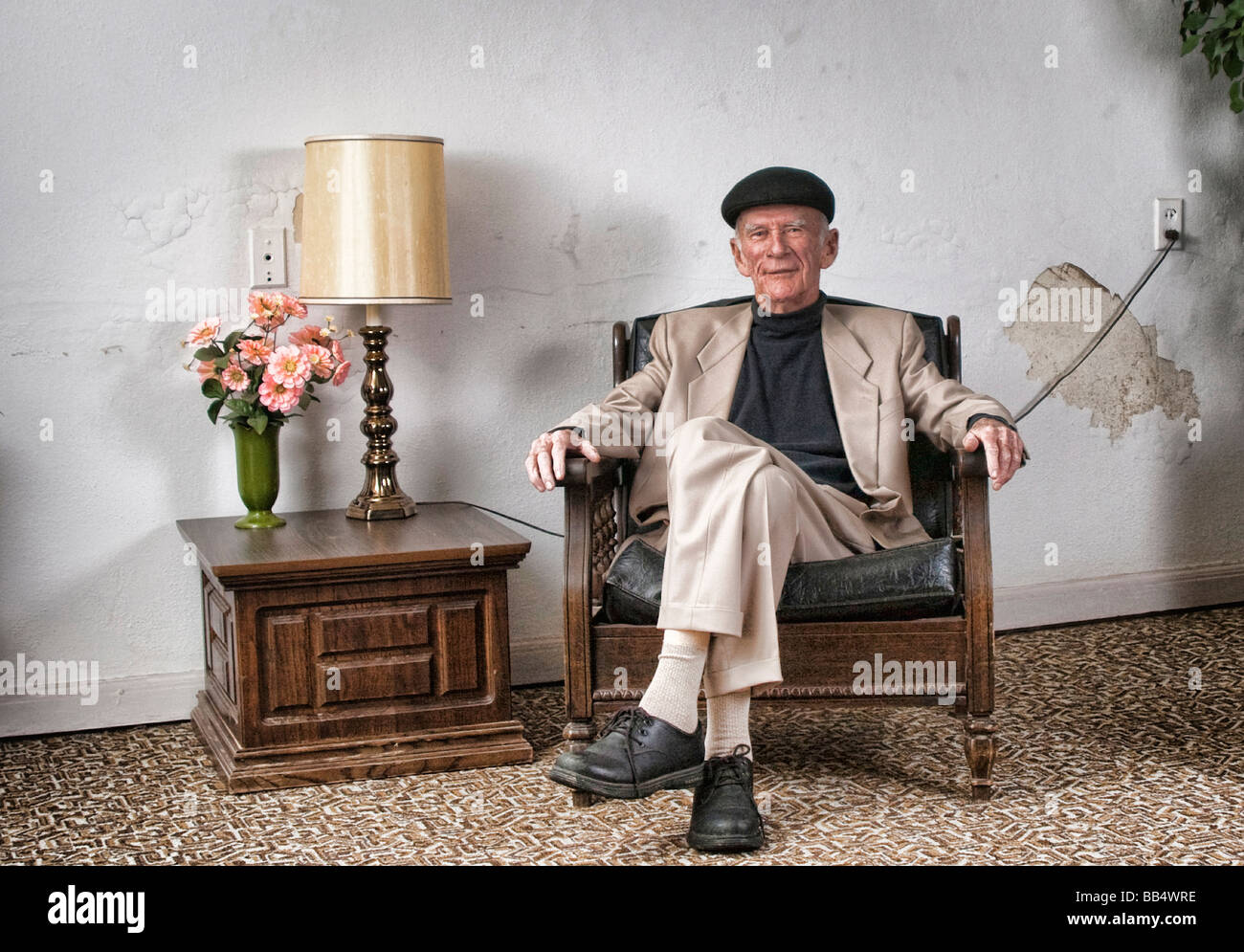 Elderly man wearing a suit sitting in a chair Stock Photo - Alamy