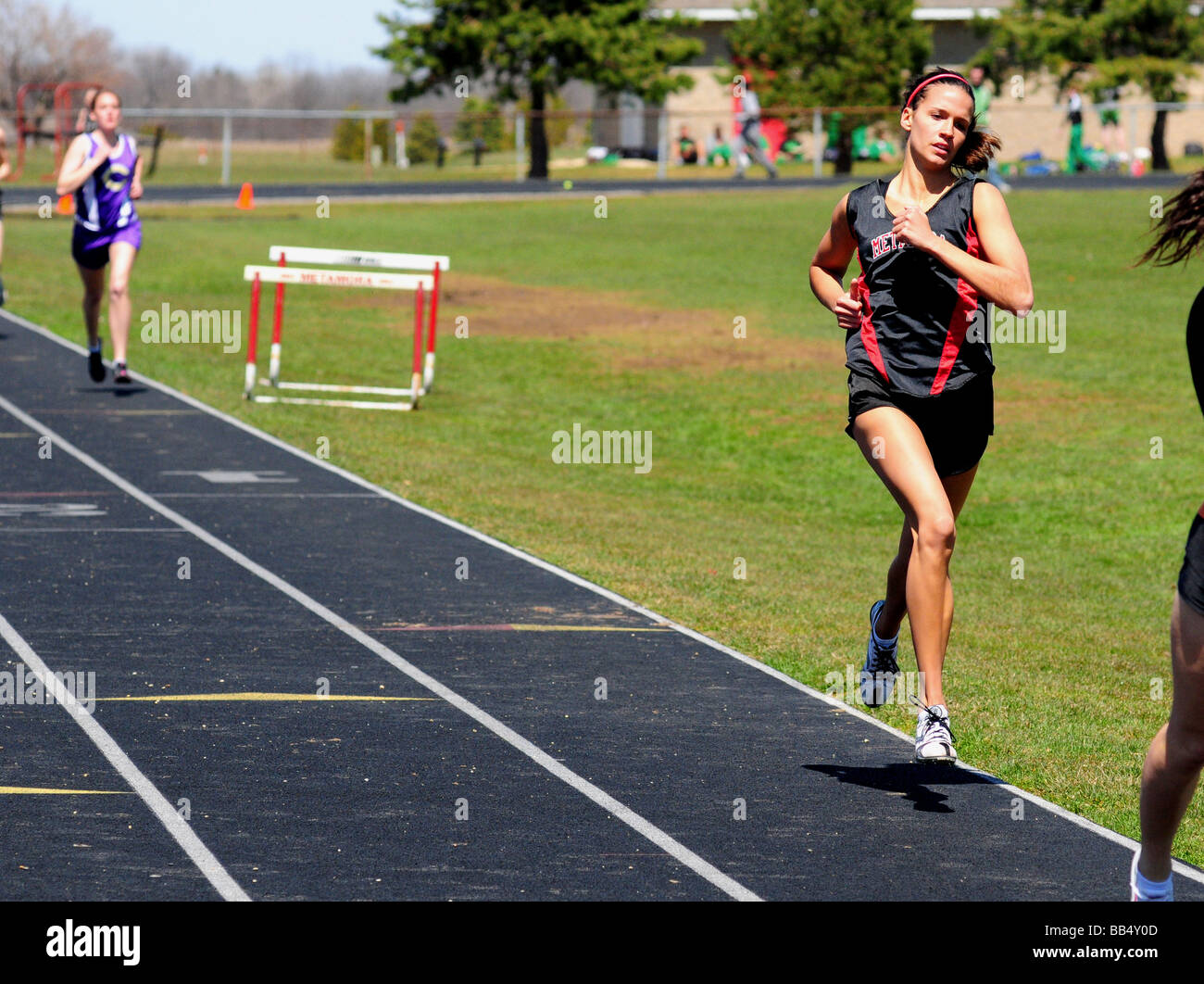 High school girl running track Stock Photo - Alamy
