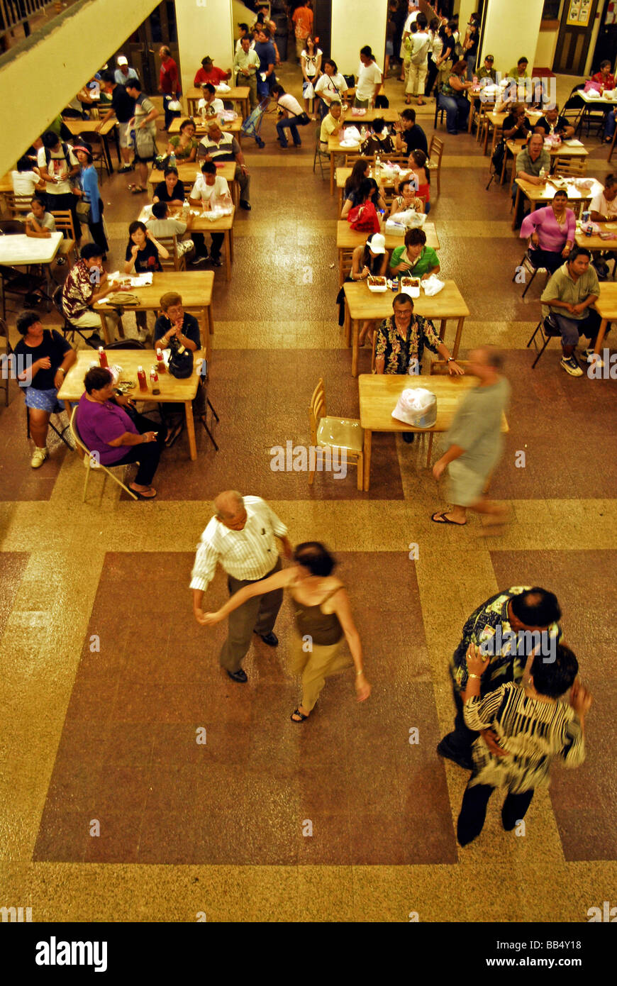 GUAM. Room with tables in rows & lines with japanese people sitting in ...