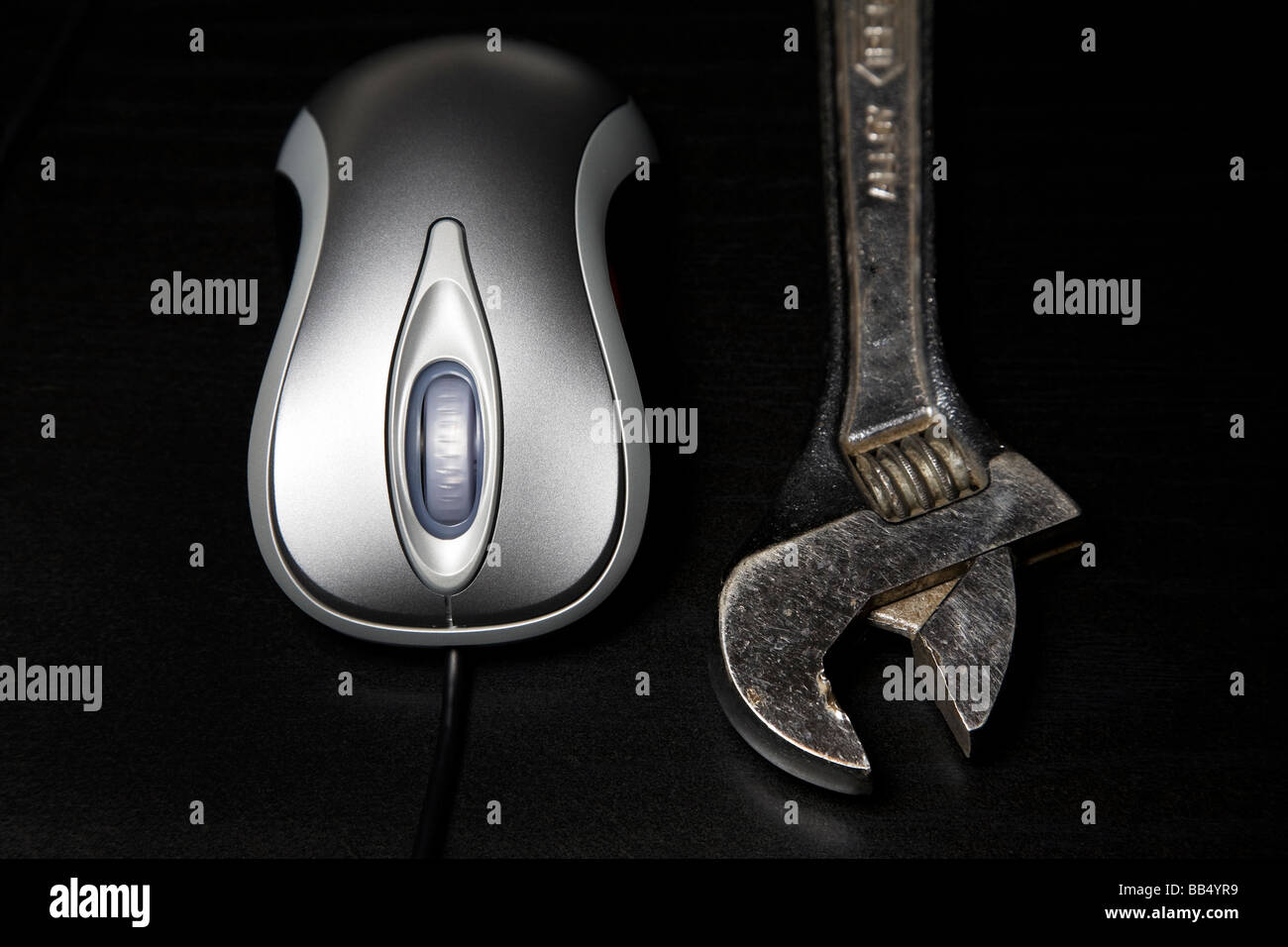 Computer mouse and wrench Stock Photo - Alamy
