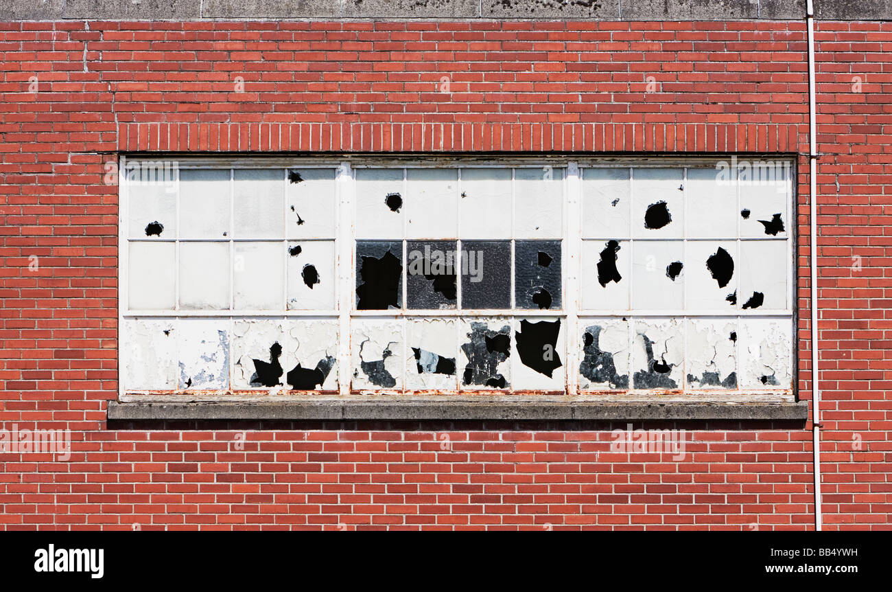 old painted broken windows on unused office building Stock Photo - Alamy