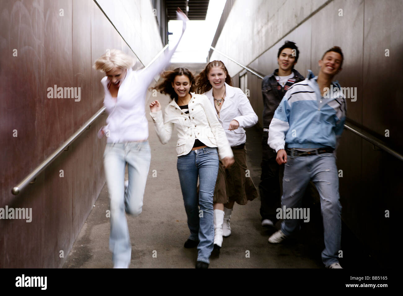 Teenager group laughing running Stock Photo - Alamy