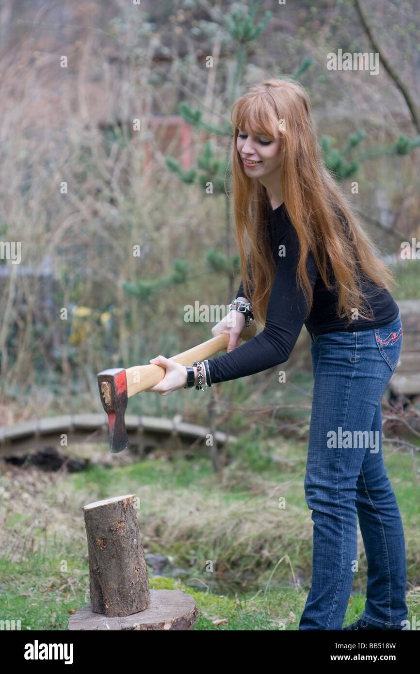Young Woman chopping Firewood in the Garden Stock Photo - Alamy