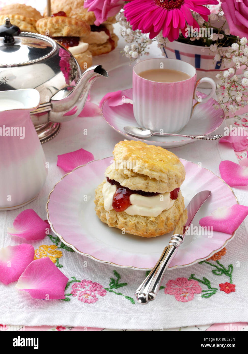 Scones with jam and clotted cream with tea set Stock Photo - Alamy