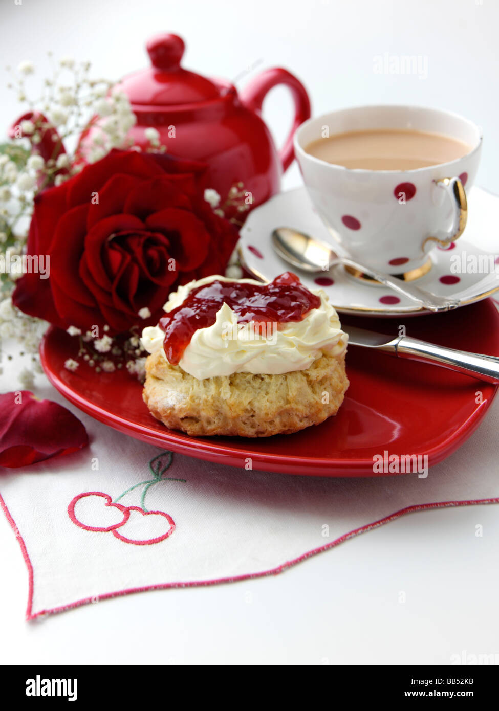 Scones with jam and clotted cream with tea set Stock Photo - Alamy