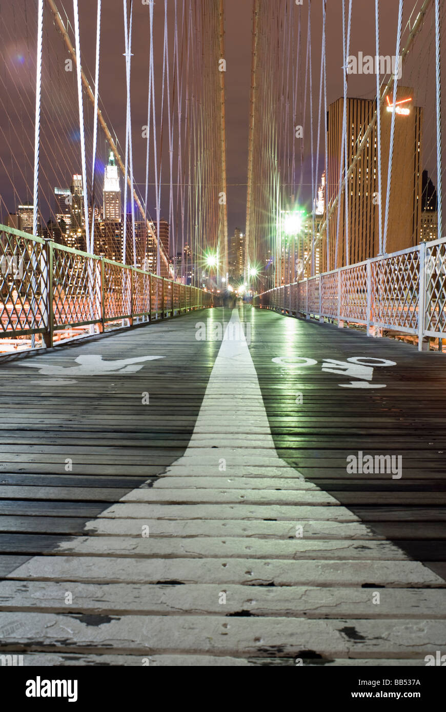 Bike and pedestrian path at night on Brooklyn Bridge in New York City ...