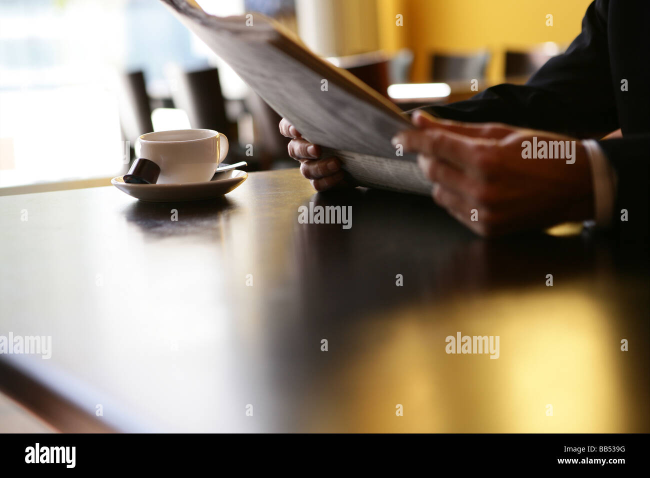young man with a newspaper in cafe Stock Photo - Alamy