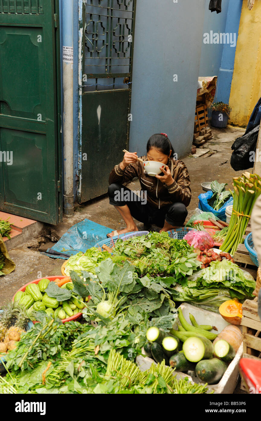Vegetable vender taking a break having breakfast, fresh market, Thanh ...