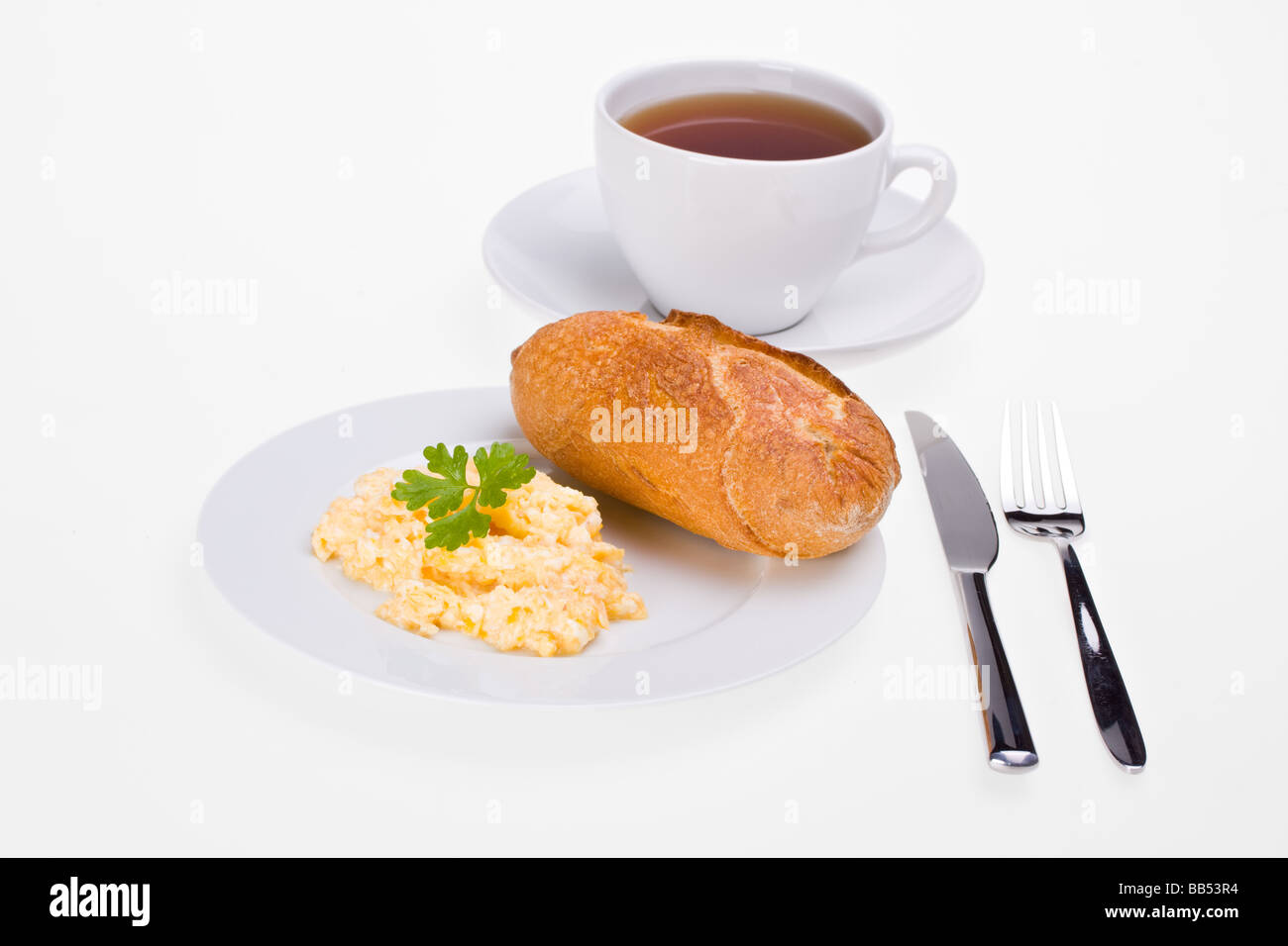 scrambled eggs and bun on a plate Stock Photo - Alamy