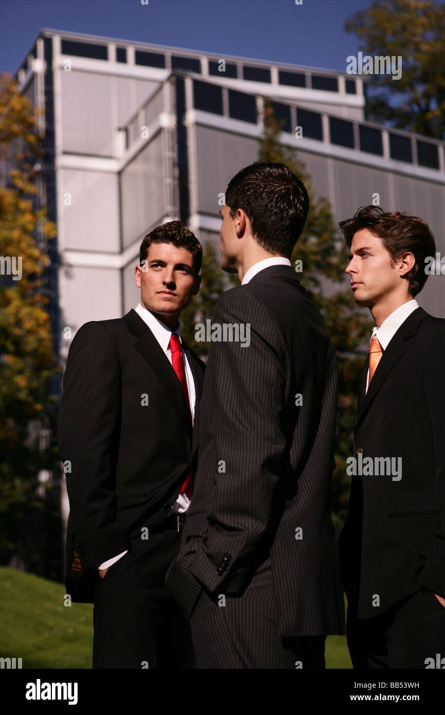 three man in front of a business building Stock Photo - Alamy