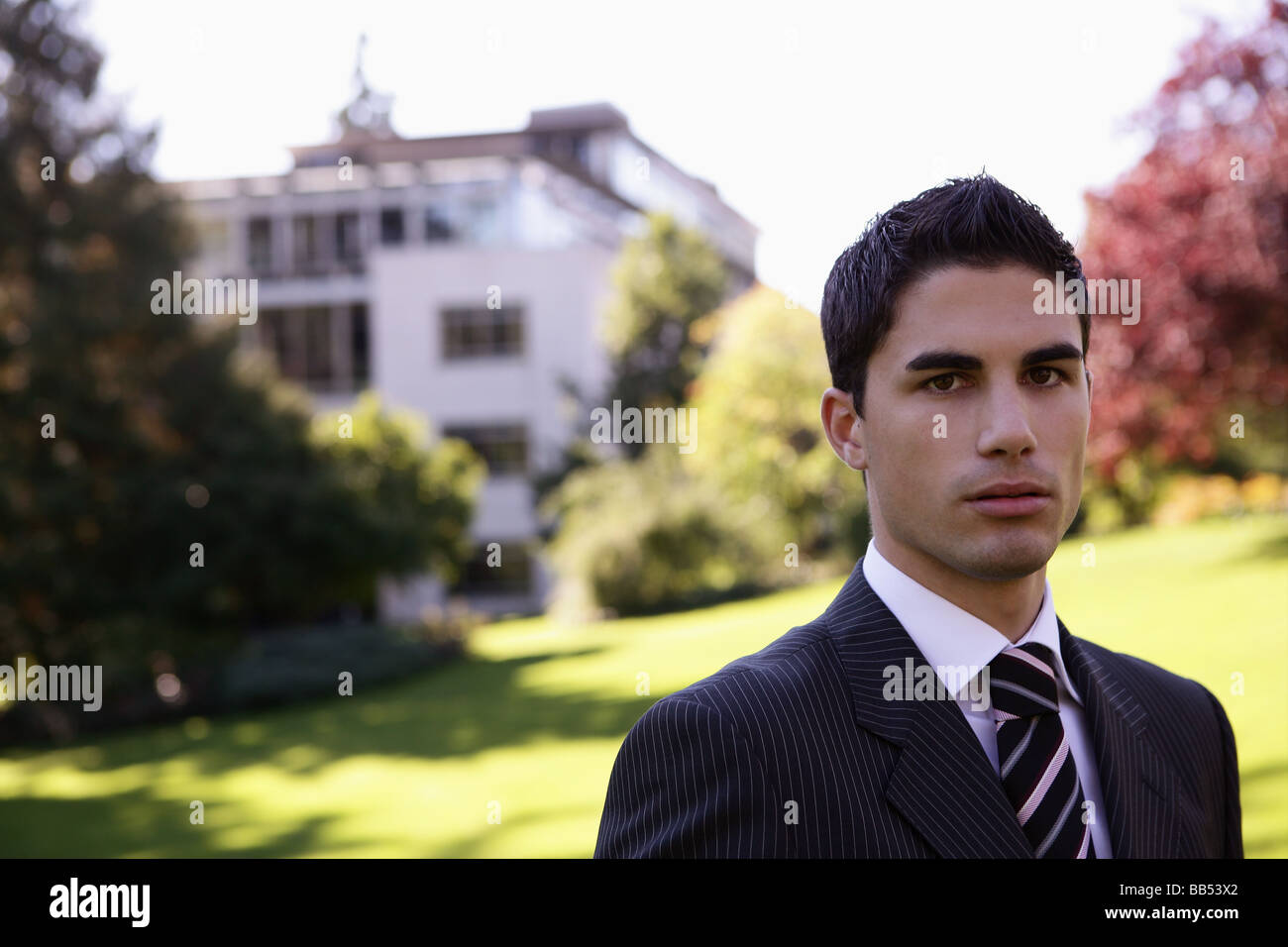 business man in front of a business building Stock Photo - Alamy