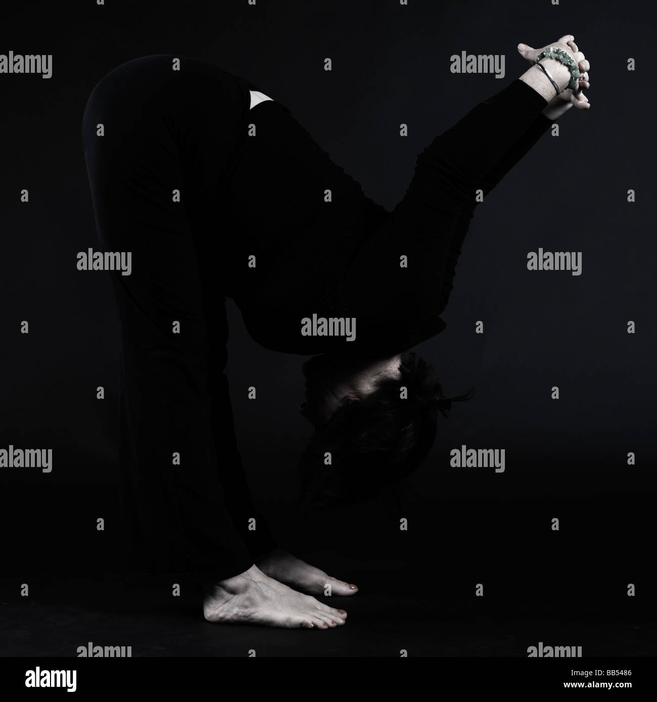 yoga position forward bend with arms extended behind the back Stock ...