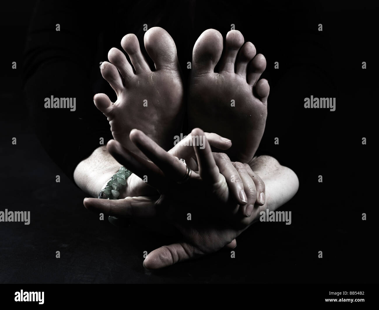 yoga pose forward bend feet toes hands fingers stretched Stock Photo ...