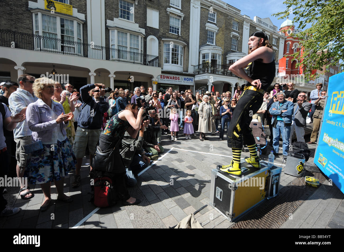 Crowd watches contortionist at The Brighton Festival outdoor event ...