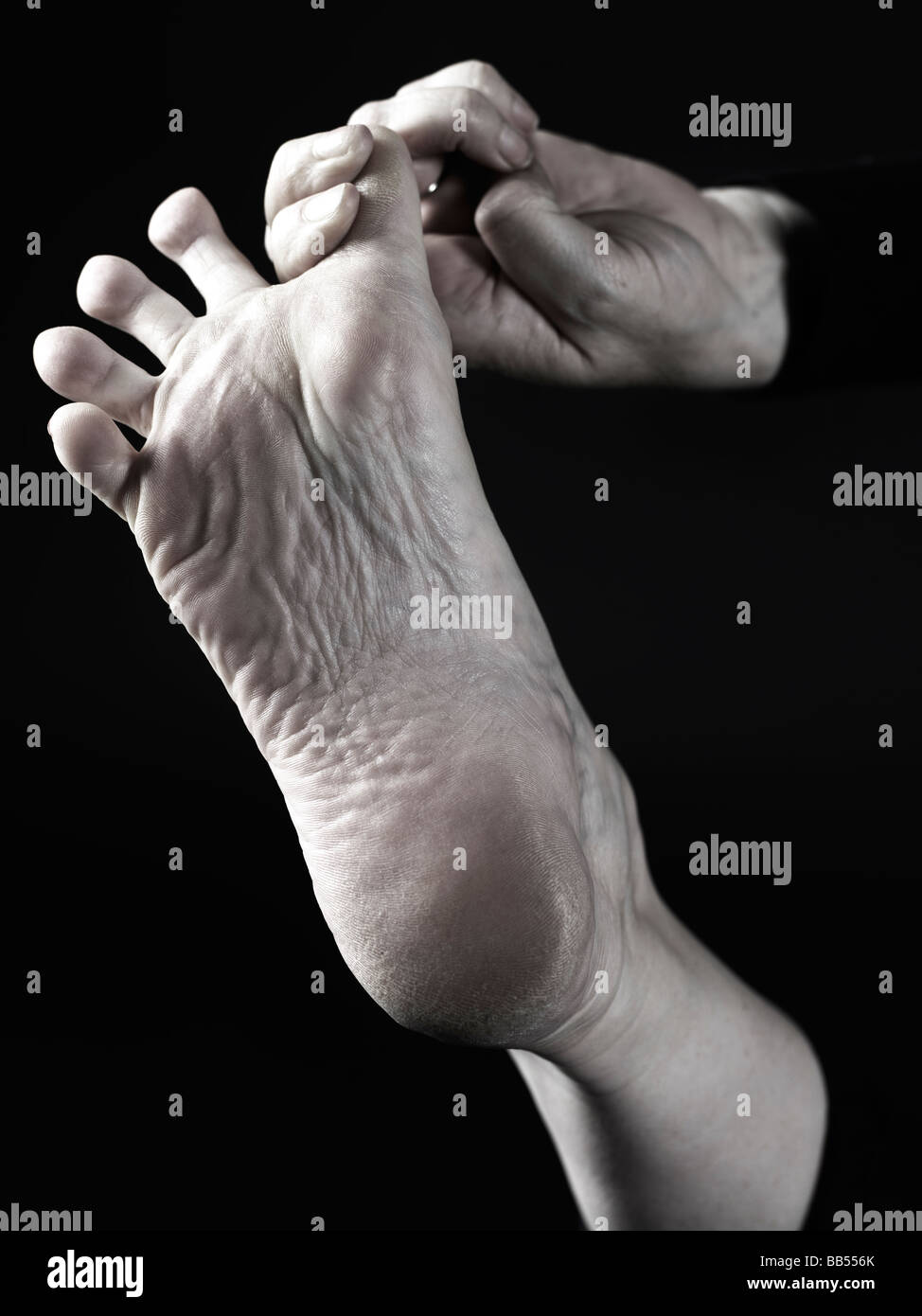 yoga pose hand holding foot Stock Photo - Alamy